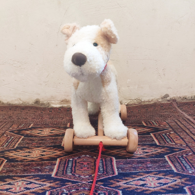 Plush dog on wooden wheels to pull
